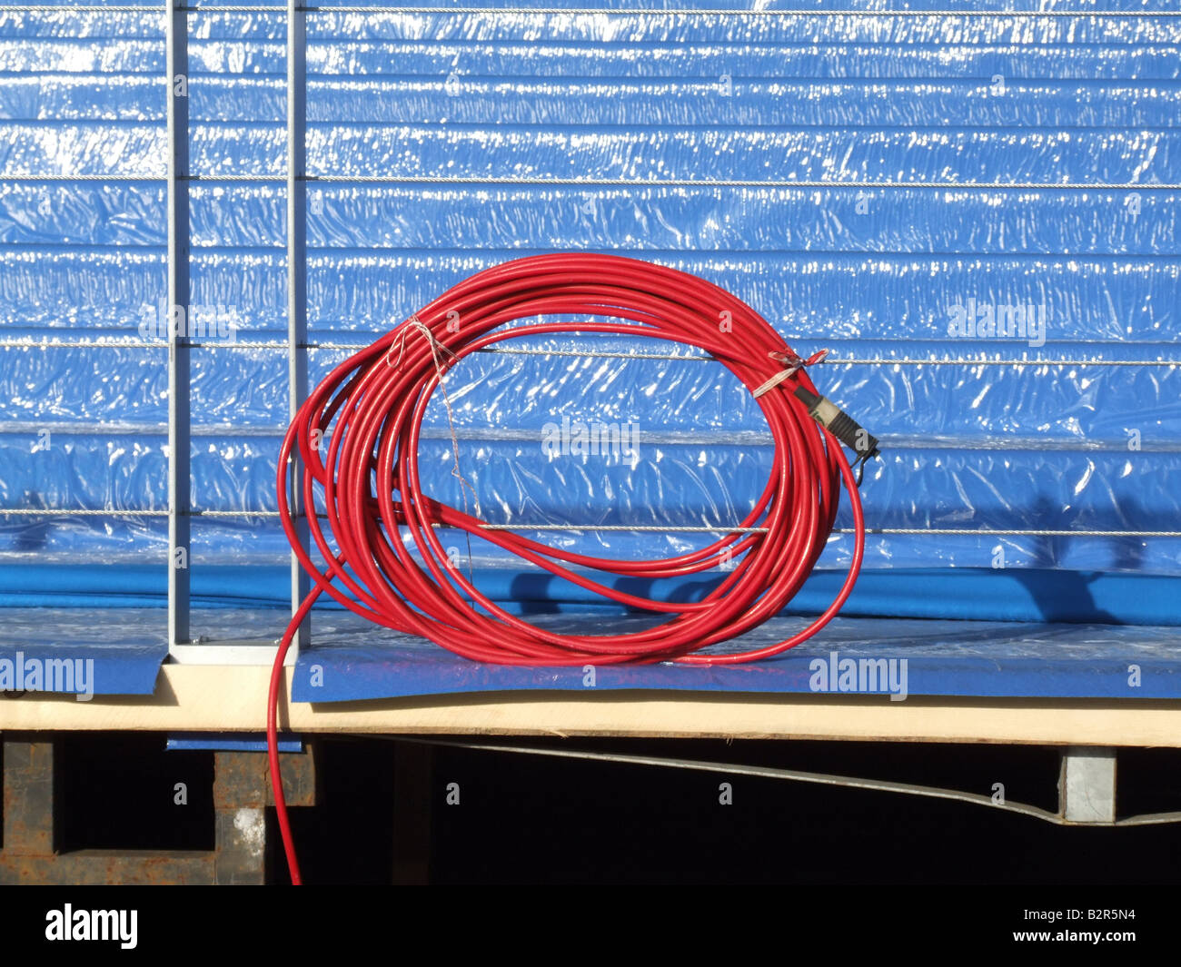 blue steps with plastic cover and red cable coil Stock Photo - Alamy