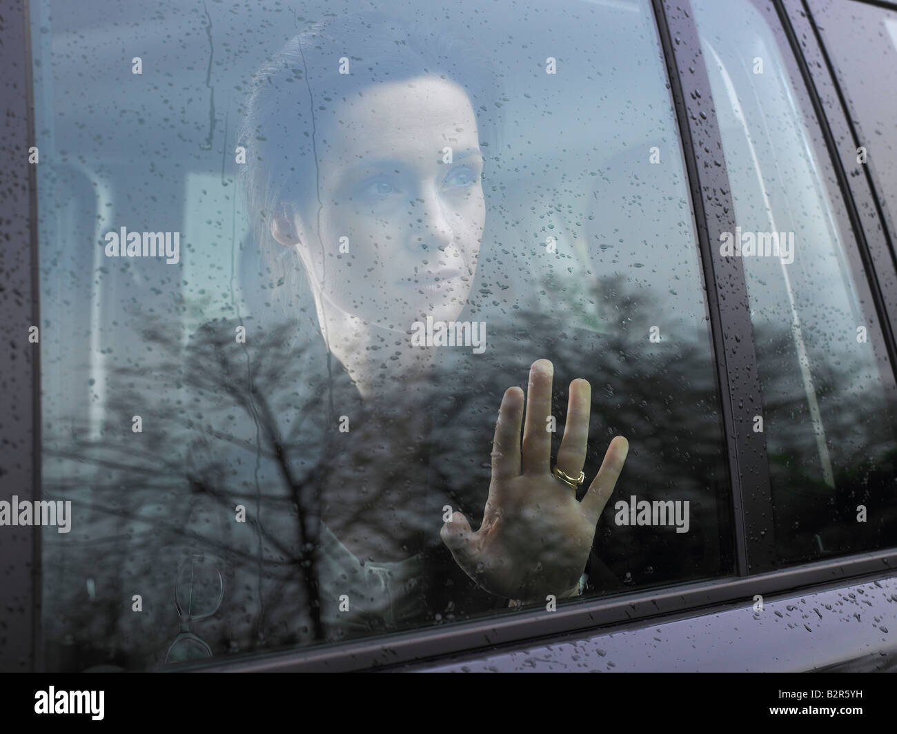 Woman looking through a car's window Stock Photo - Alamy