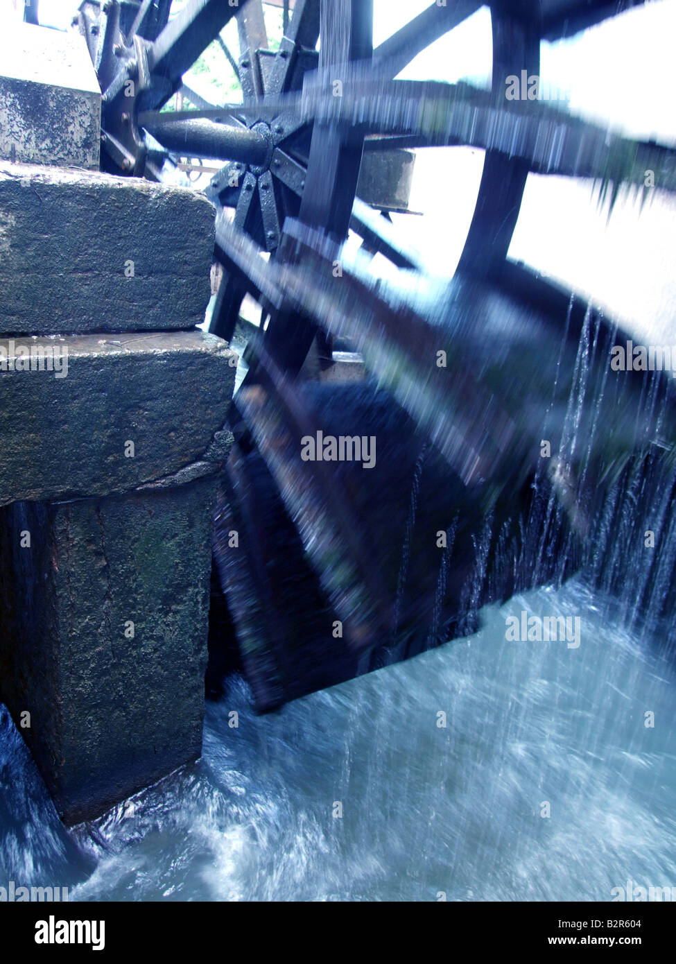 energy making industrial water wheel in action Stock Photo - Alamy