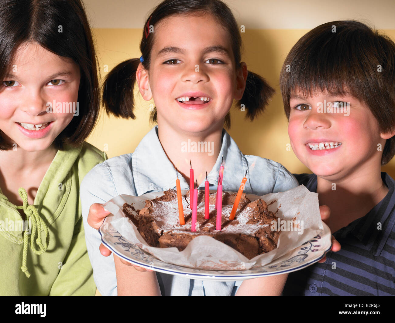 Children holding a birthday cake Stock Photo - Alamy