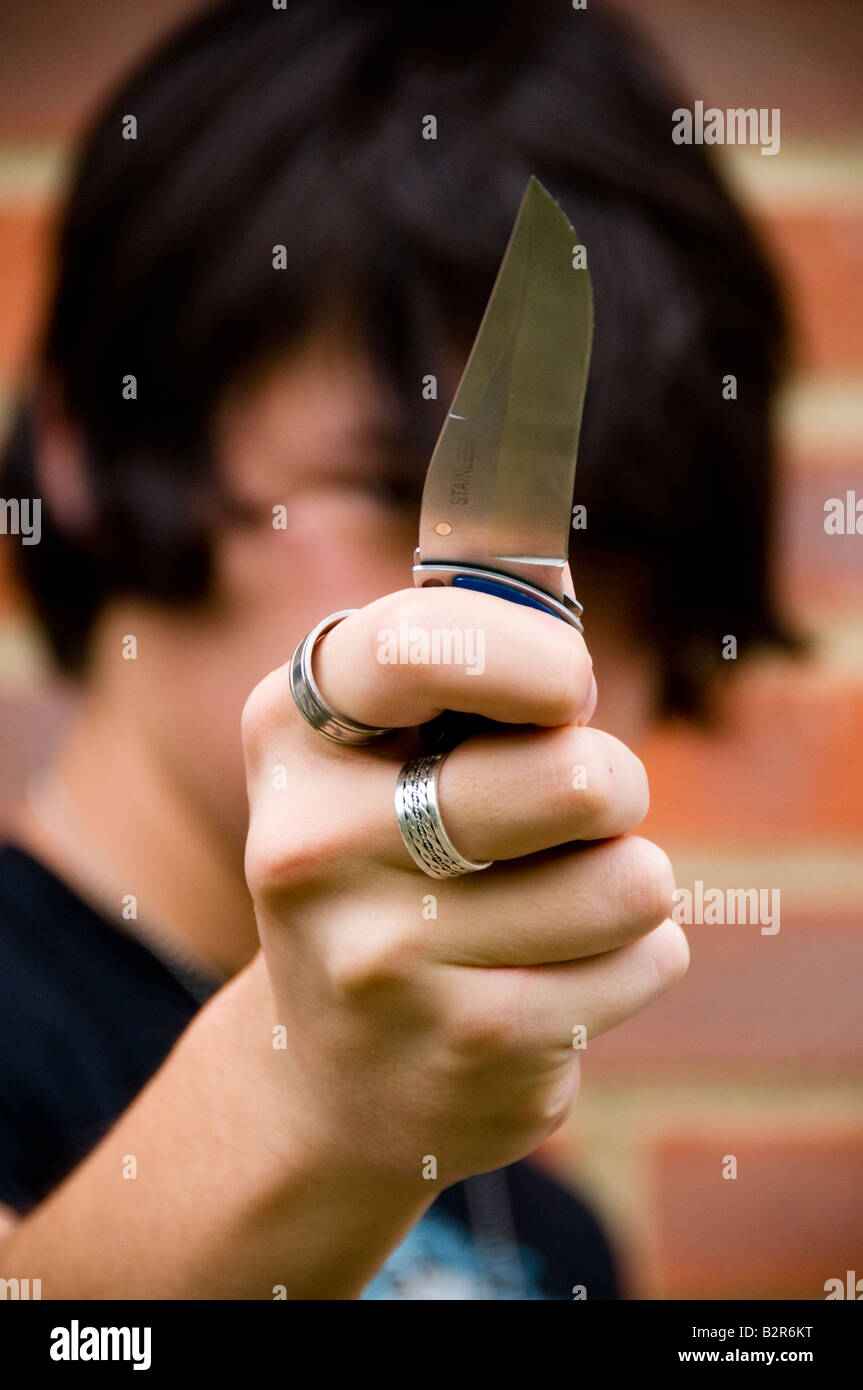 a young man holding a knife Stock Photo - Alamy