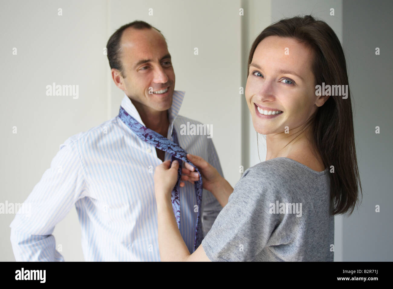 Woman knotting tie not pregnant hi-res stock photography and images - Alamy