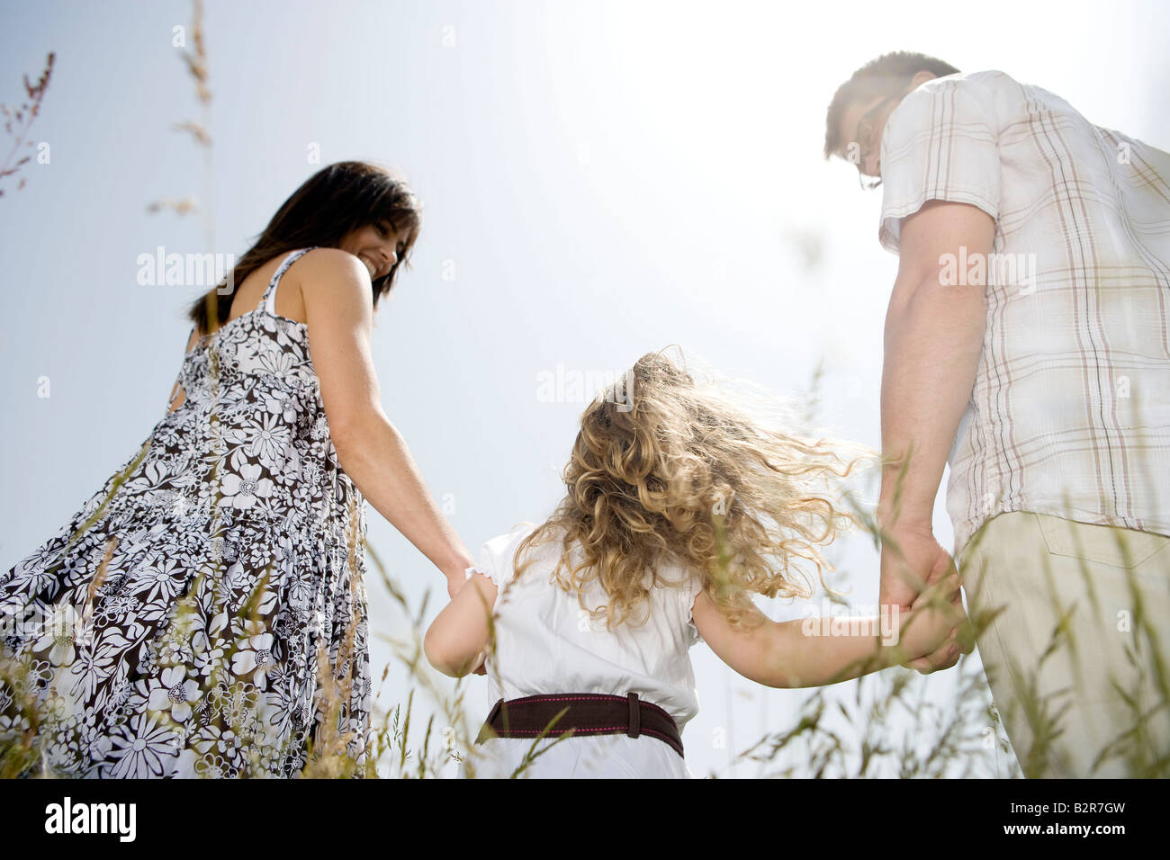 Family holding hands, rear view Stock Photo - Alamy