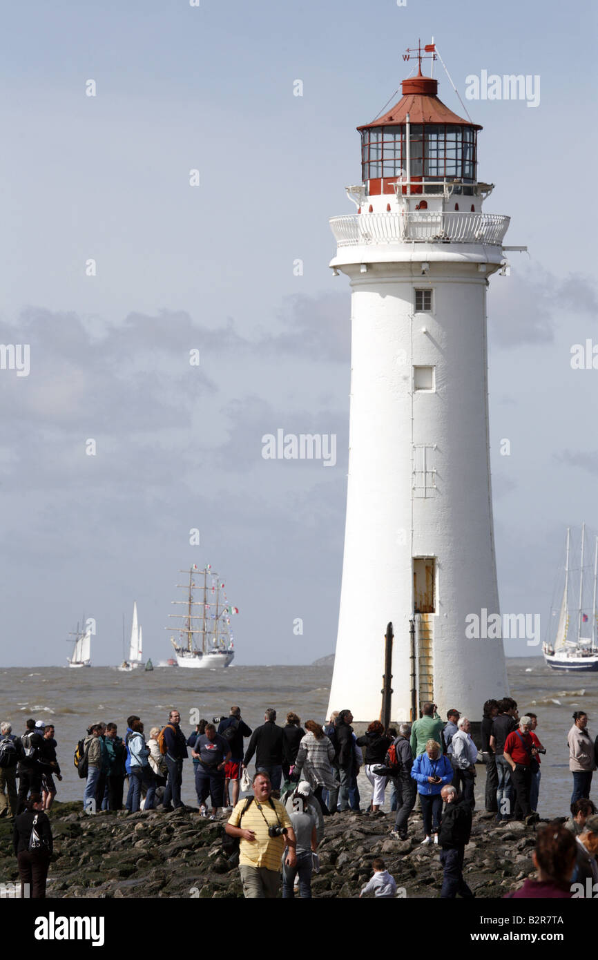 Spectators watch the Tall Ships Fleet setting sail passing Rock Light ...