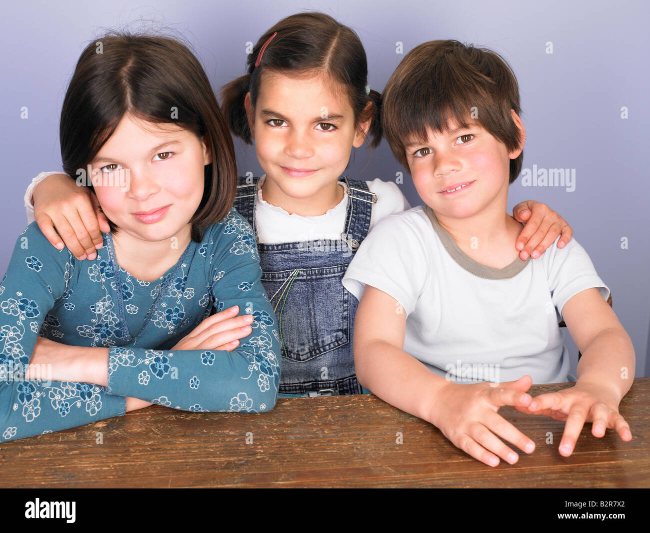 Children at their desk, smiling Stock Photo - Alamy