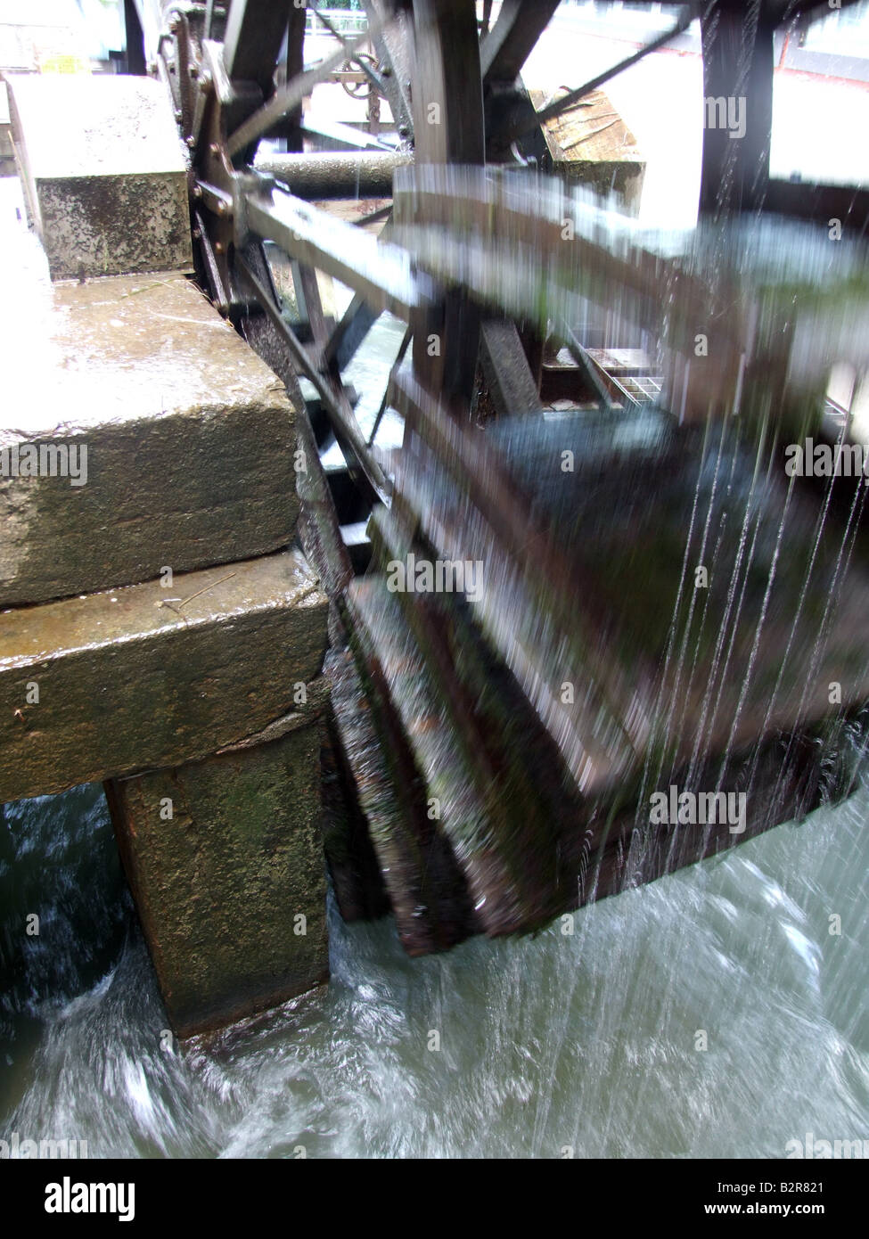 energy making industrial water wheel in action Stock Photo - Alamy