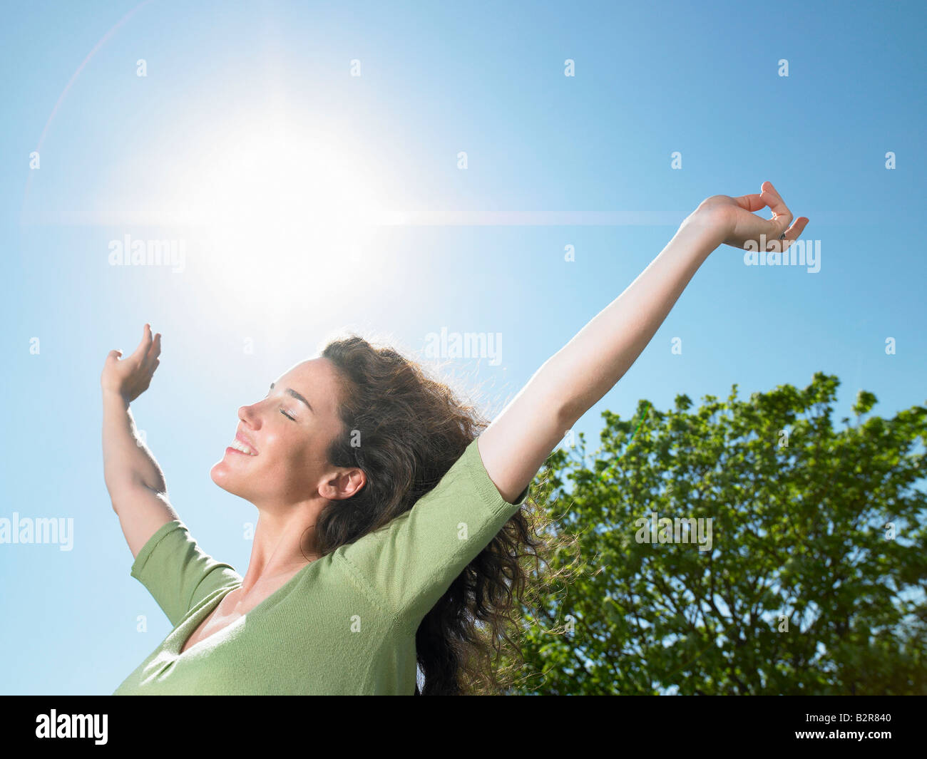 Woman enjoying the sun Stock Photo - Alamy