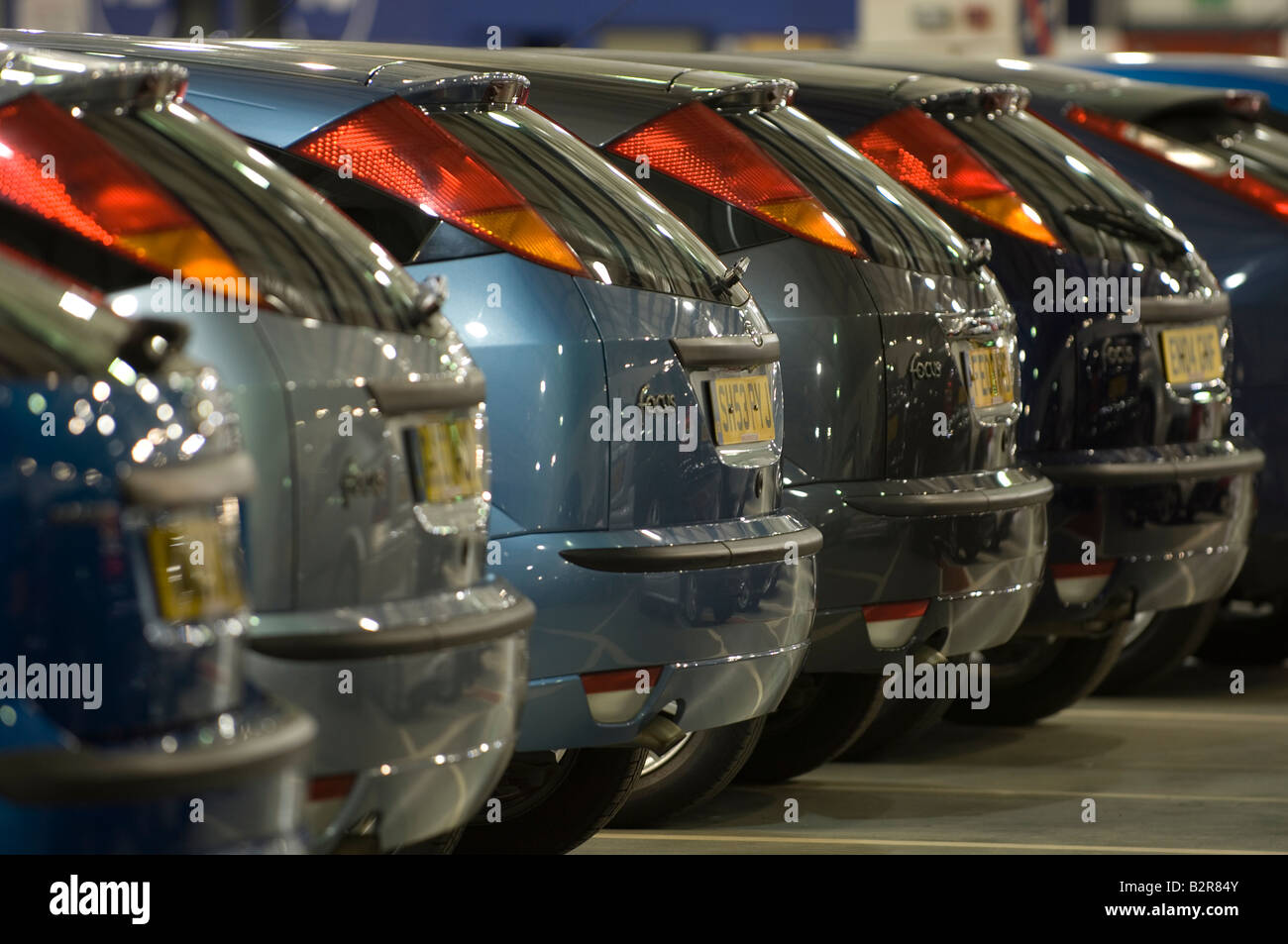 Rear of cars in a showroom Stock Photo - Alamy