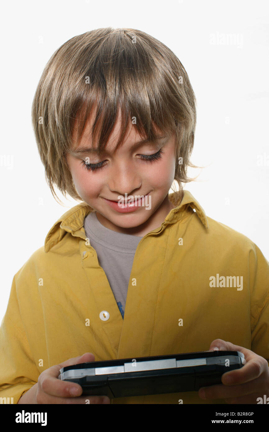 Young boy playing with handheld game Stock Photo - Alamy