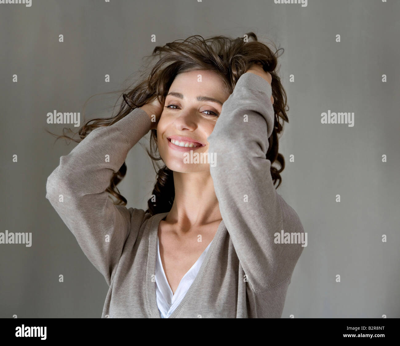 Woman portrait with hands in hair Stock Photo - Alamy