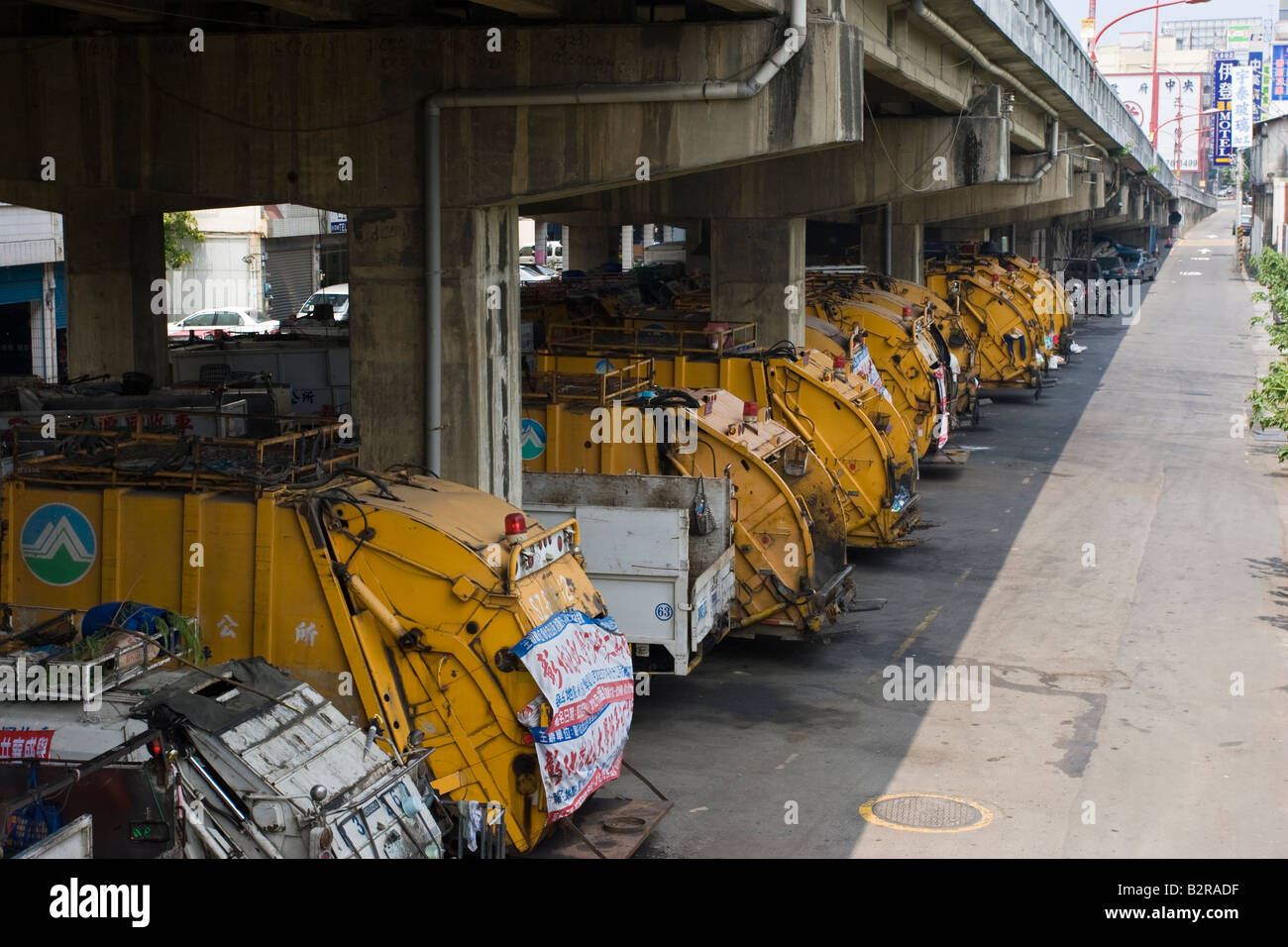 Garbage and recycling trucks lined up under an overpass Changhua Taiwan ...