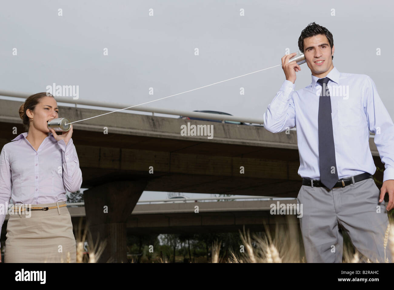 Business team talking through tin cans Stock Photo - Alamy