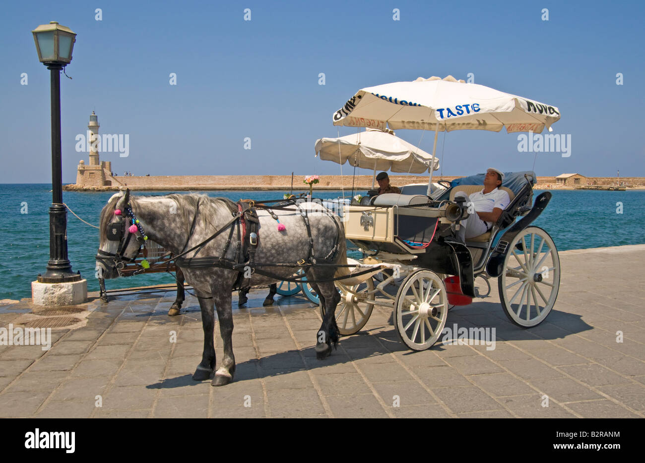 Hania, Crete, Greece. Horse drawn Carriages by the harbour Stock Photo ...