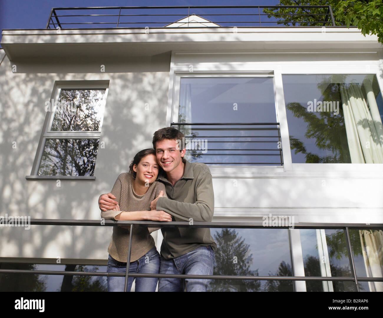 Couple on a terrace, smiling Stock Photo - Alamy