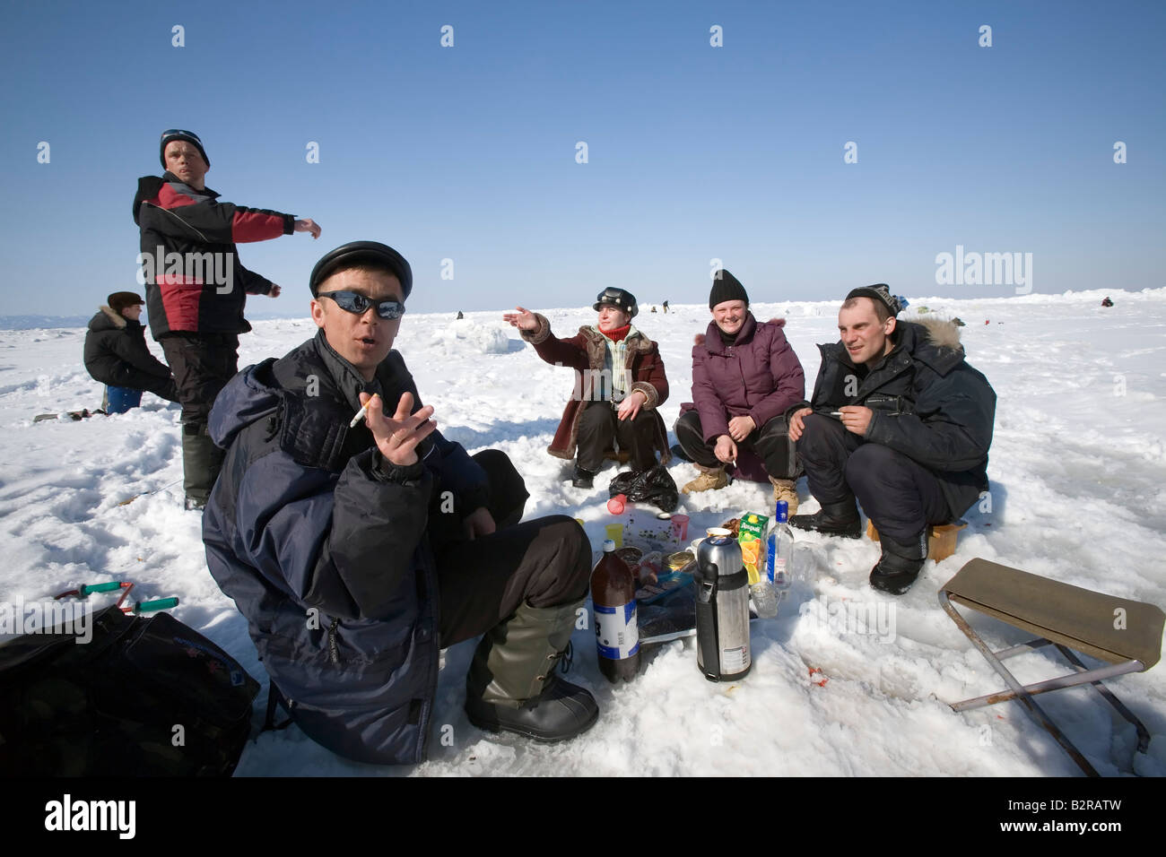 A group of Russians are ice fishing on the Sea of Okhotsk near Sakhalin ...