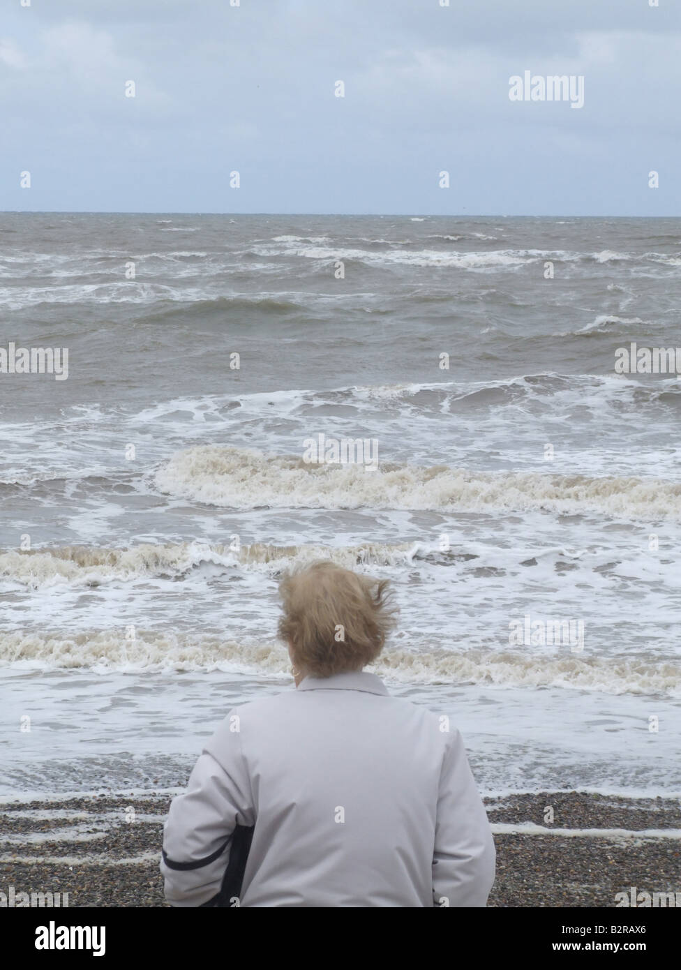 Old woman standing by beach in rhyl hi-res stock photography and images ...