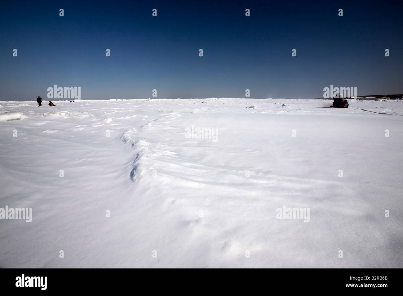 Ice fishermen are fishing on the frozen seas at the west coast of ...