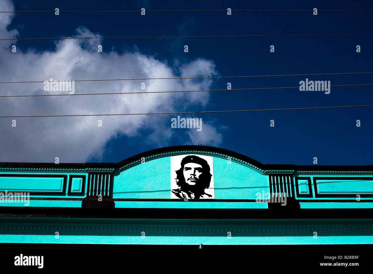 A bright blue building adorned with an image of Ernesto Che Guevara in ...