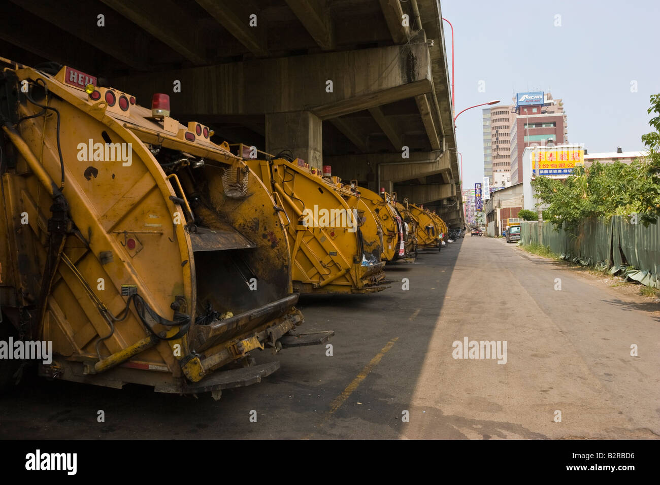 Garbage and recycling trucks lined up under an overpass Changhua Taiwan ...
