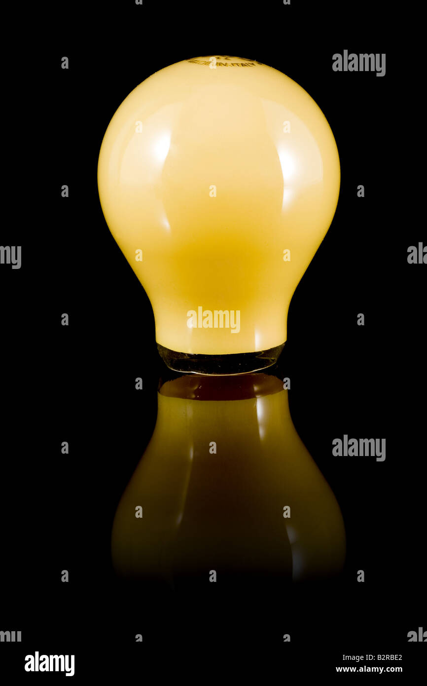broken yellow lightbulb isolated on black Stock Photo - Alamy