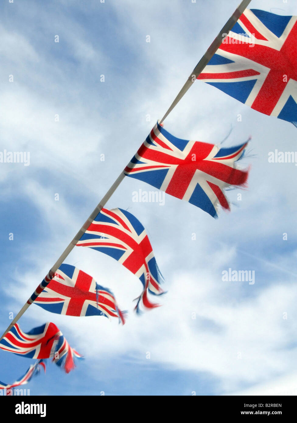 many small union jack british flags and blue sky Stock Photo - Alamy