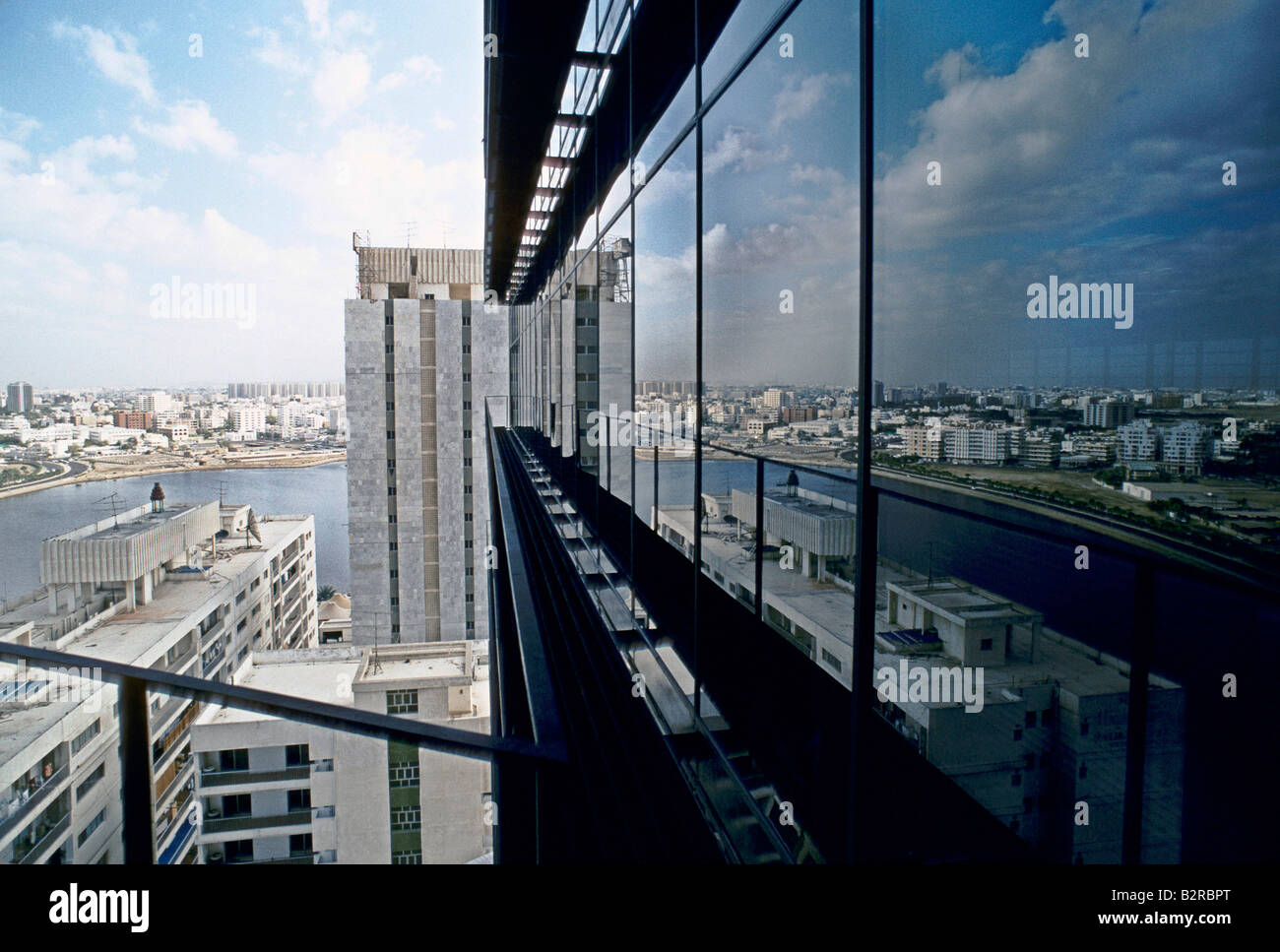 the reflection of a city skyline in a skyscraper glass window Stock ...