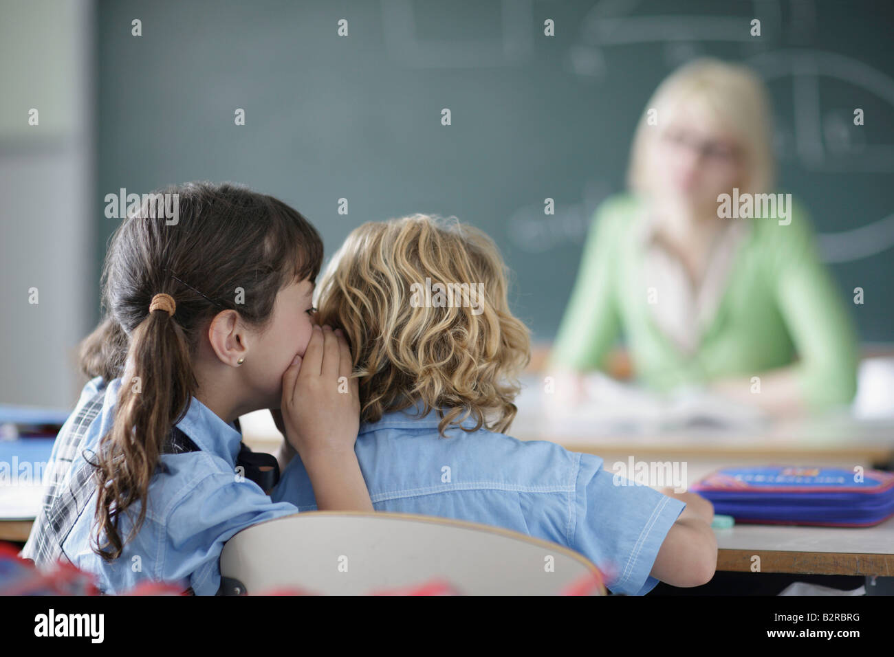 School girl whispering Stock Photo - Alamy