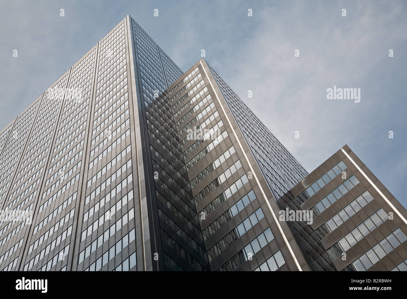 A modern building is under a stormy dark cloudy sky Stock Photo - Alamy