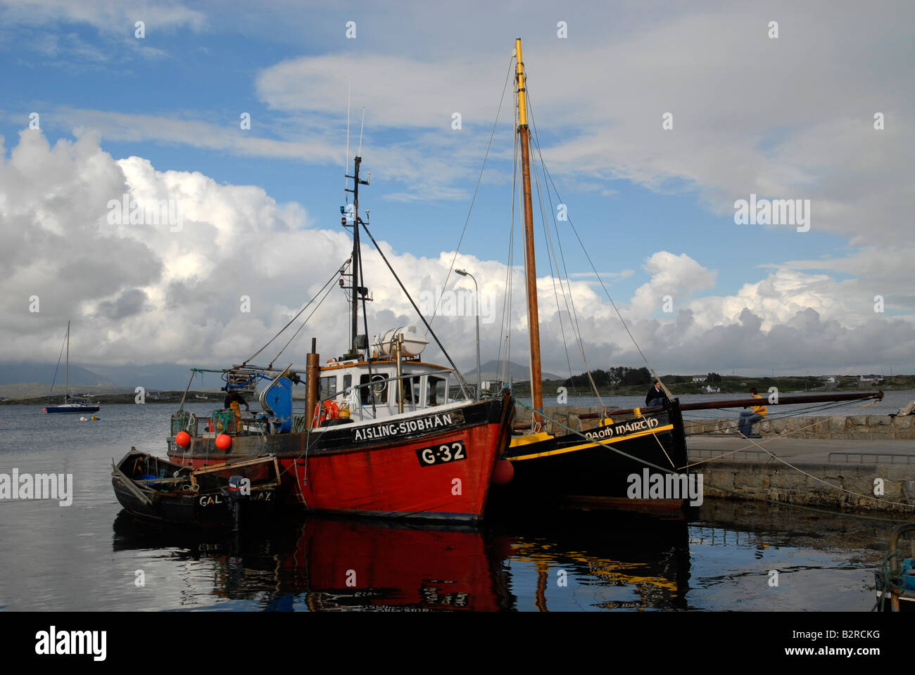 Pier at Roundstone (Connemara) with a historic sailing boat and fishing ...