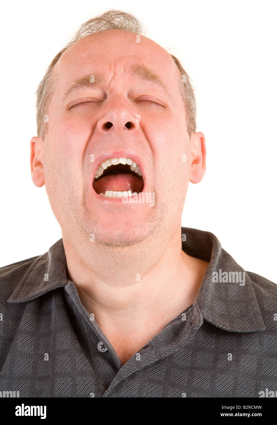 A middle aged man is sneezing loudly Stock Photo - Alamy