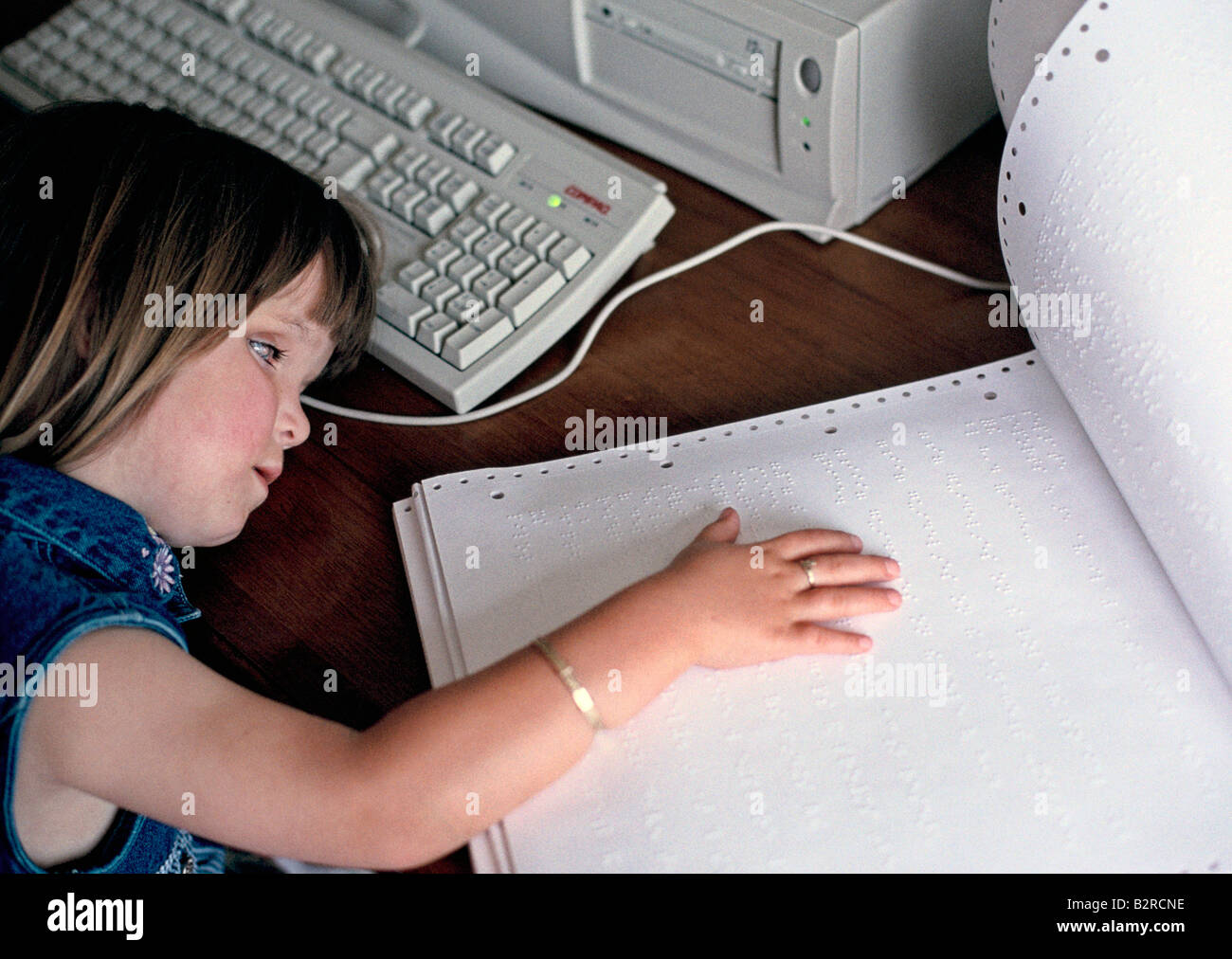 girl learning to read braille with aid of computer Stock Photo - Alamy