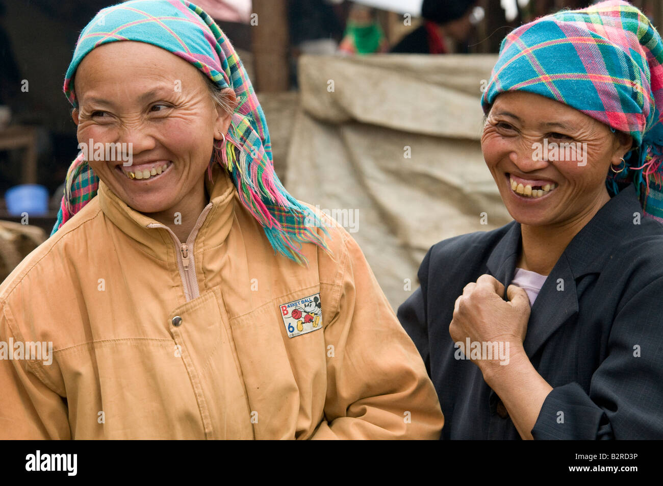 Two old flower Hmong women wearing traditional head scarfs laughing in ...