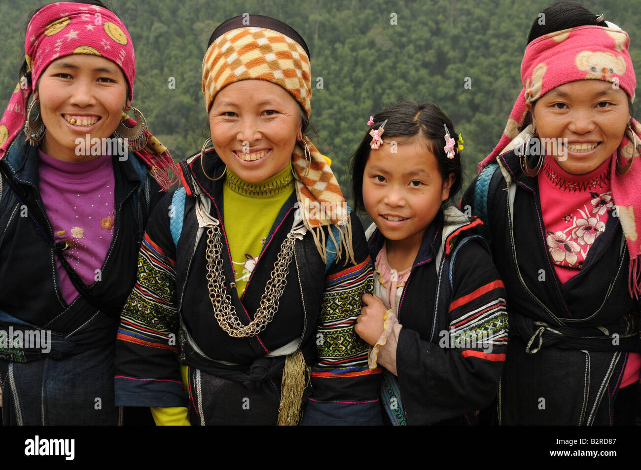 Four Hmong girls wearing traditional costume smiling at the camera in ...