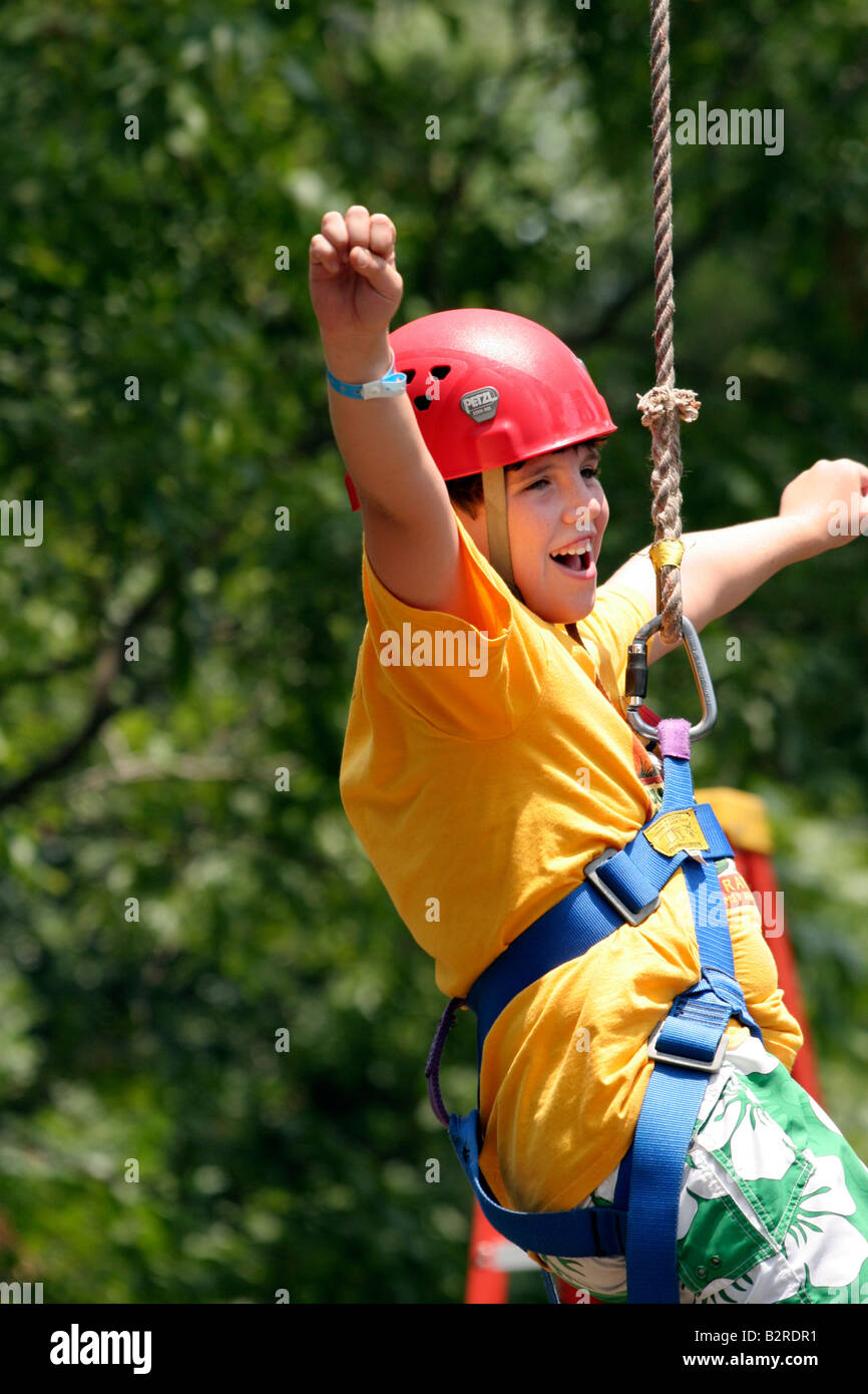 Young boy rides zip line at summer camp Stock Photo - Alamy