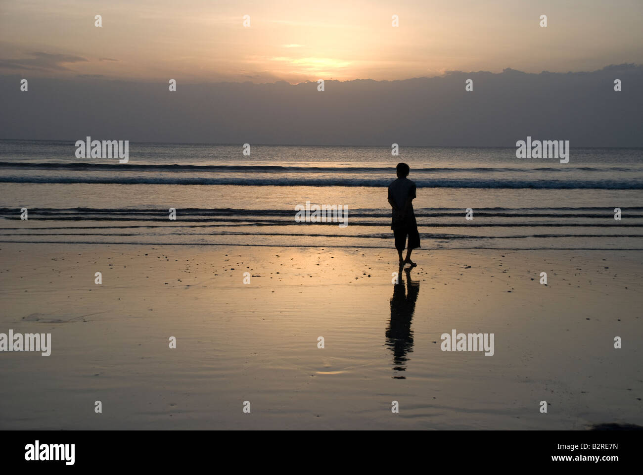 kuta bali indonesia beach bay sea ocean surf sunset man woman walk ...