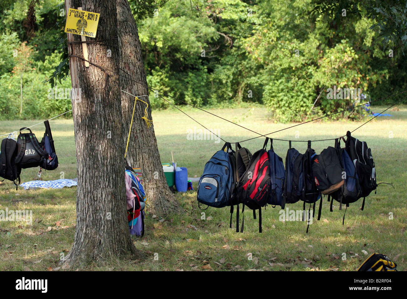 Backpacks of summer camp attendees hang from ropes in order to keep ...