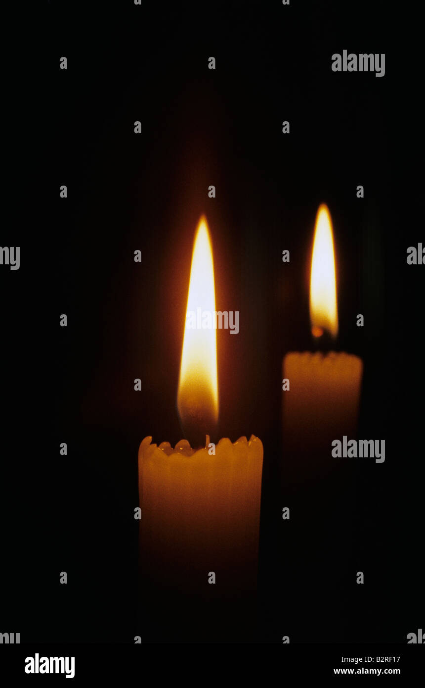 Two lit candles in dark room Stock Photo - Alamy