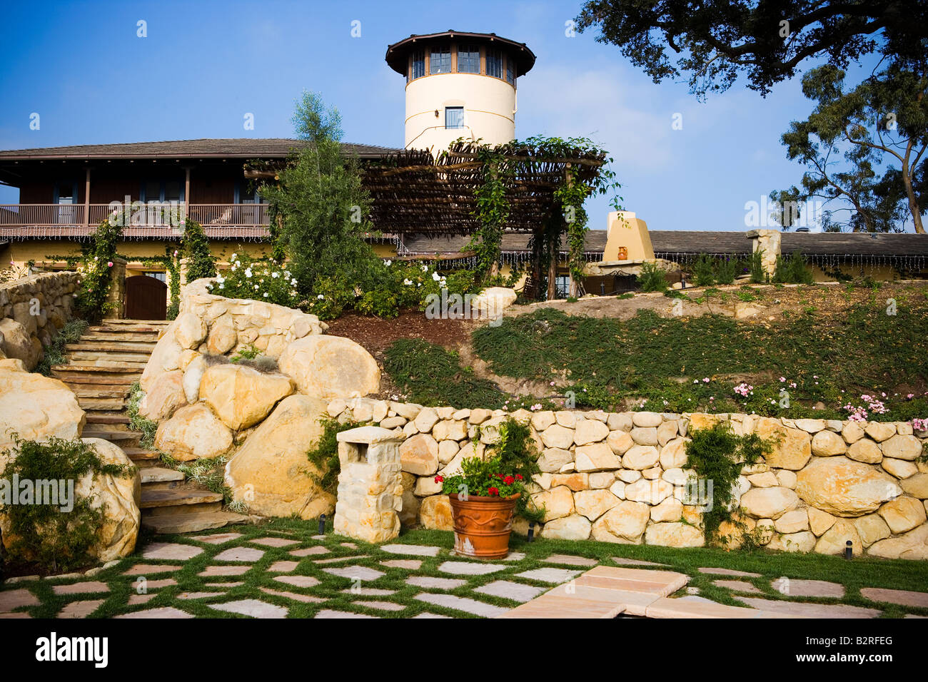 Stone steps leading up to a large Spanish style home Stock Photo - Alamy
