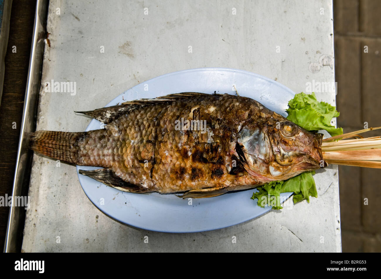 Tasty fish grilled in Thai style Stock Photo - Alamy