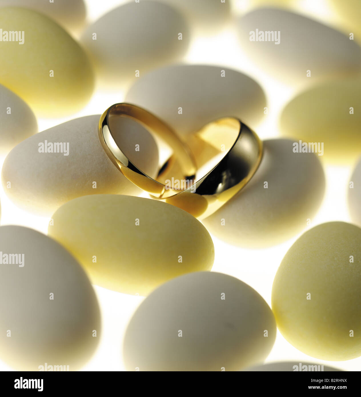 a pair of wedding rings on a background of sugared almonds Stock Photo ...