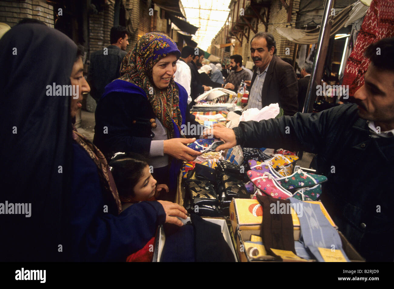 Iraqis shop at an outdoor market in Kadhimiya, a district in Baghdad ...