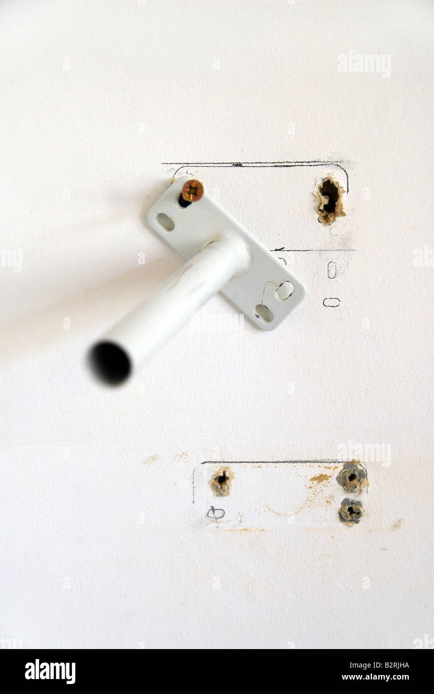A shelf bracket hanging off the wall during DIY repairs Stock Photo - Alamy