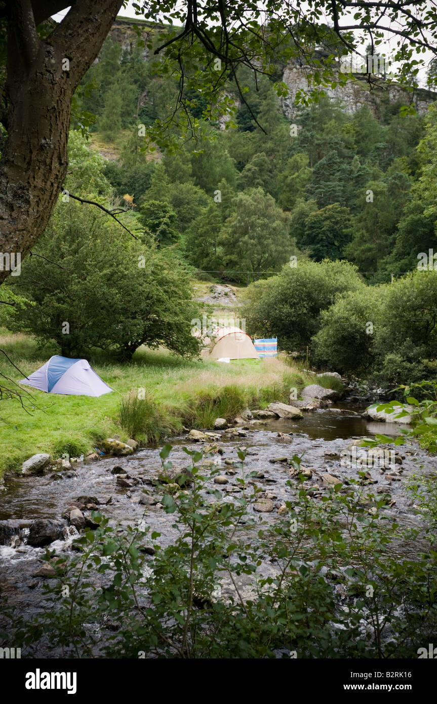 Tents in a campsite on the edge of a stream below Pistyll Rhaeadr ...