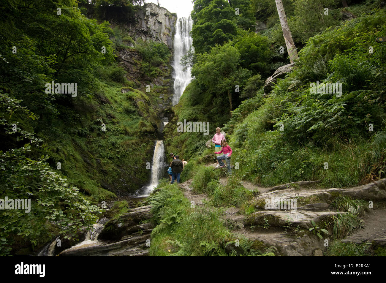 people walking on path near Pistyll Rhaeadr waterfall, the tallest in ...
