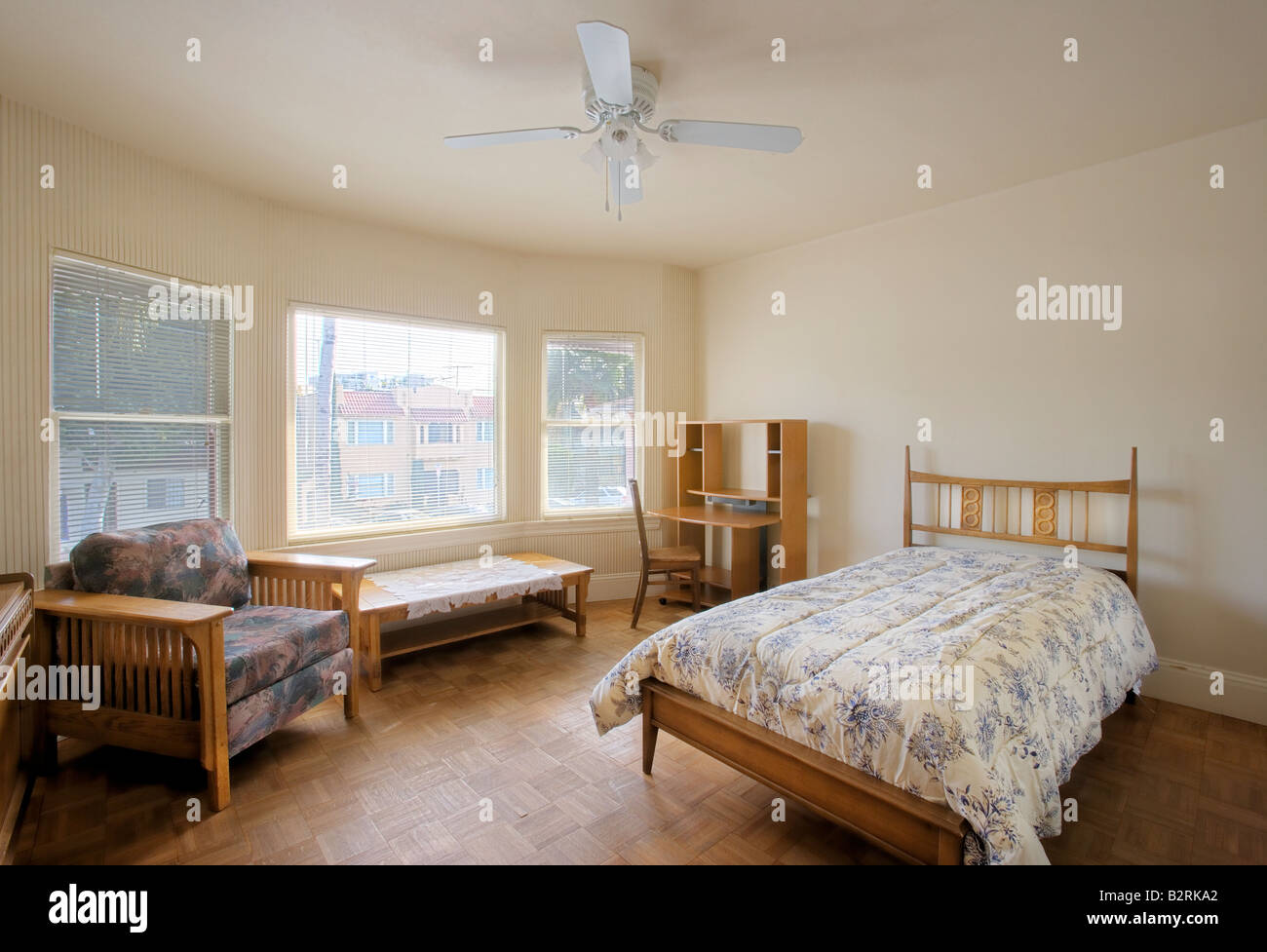 Sparse bedroom with a large window Stock Photo - Alamy