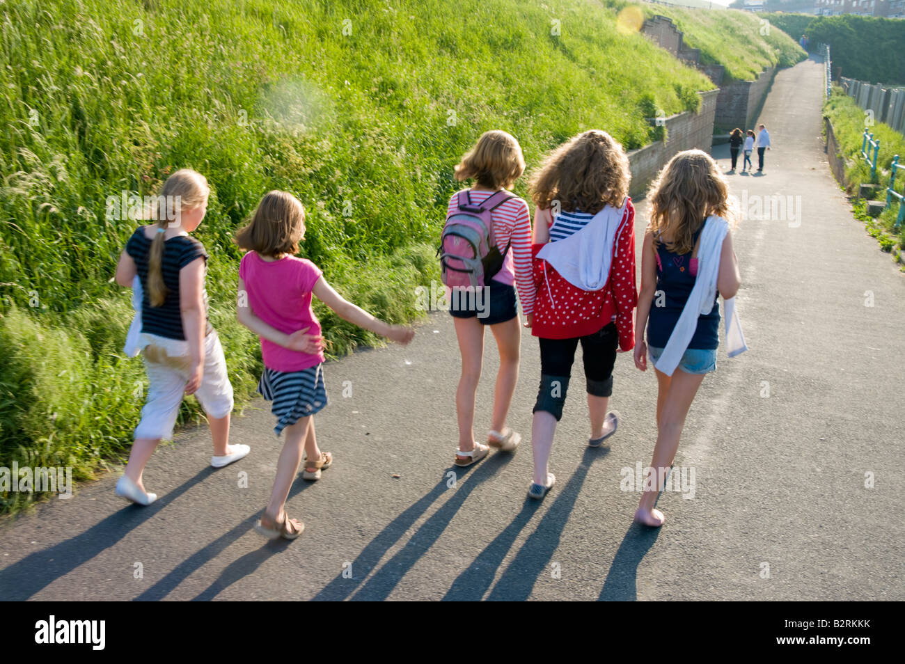 girls children walking along path Stock Photo - Alamy