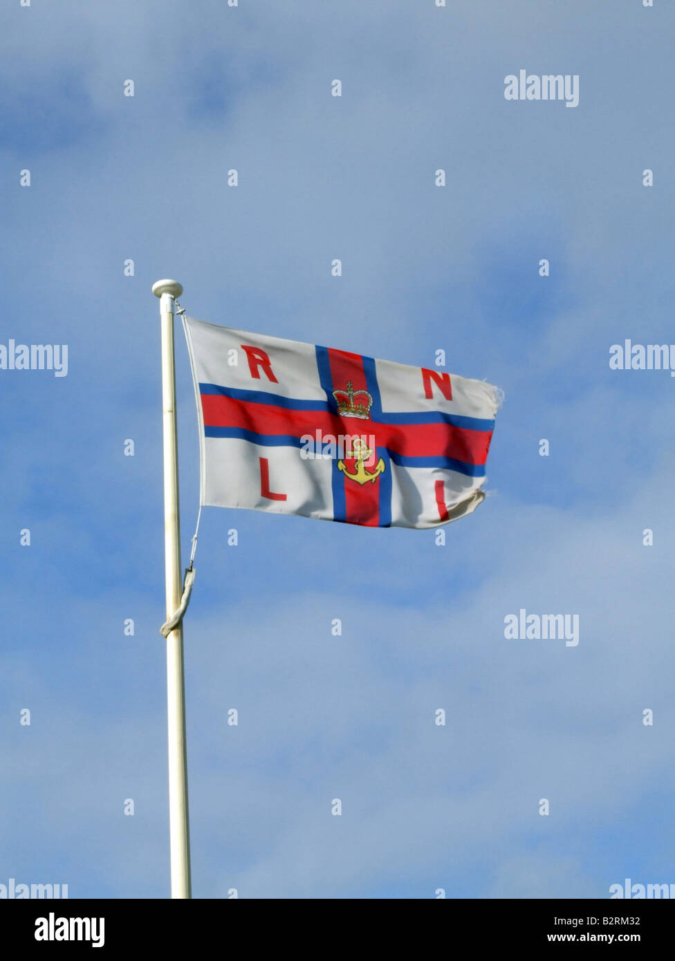 rnli lifeboat station flag flying in blue sky Stock Photo - Alamy