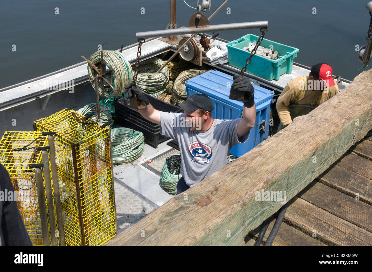 Escuminac Wharf with fishermen unloading lobster traps in New Brunswick ...