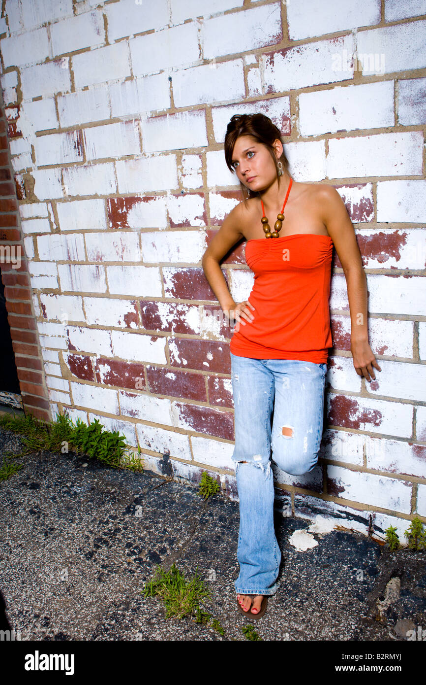 Young girl portrait against brick wall Stock Photo - Alamy