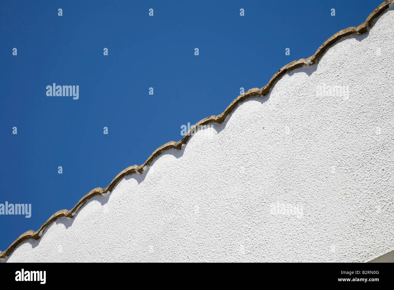Edge of a Spanish house with a white rendered wall with tiles Stock ...